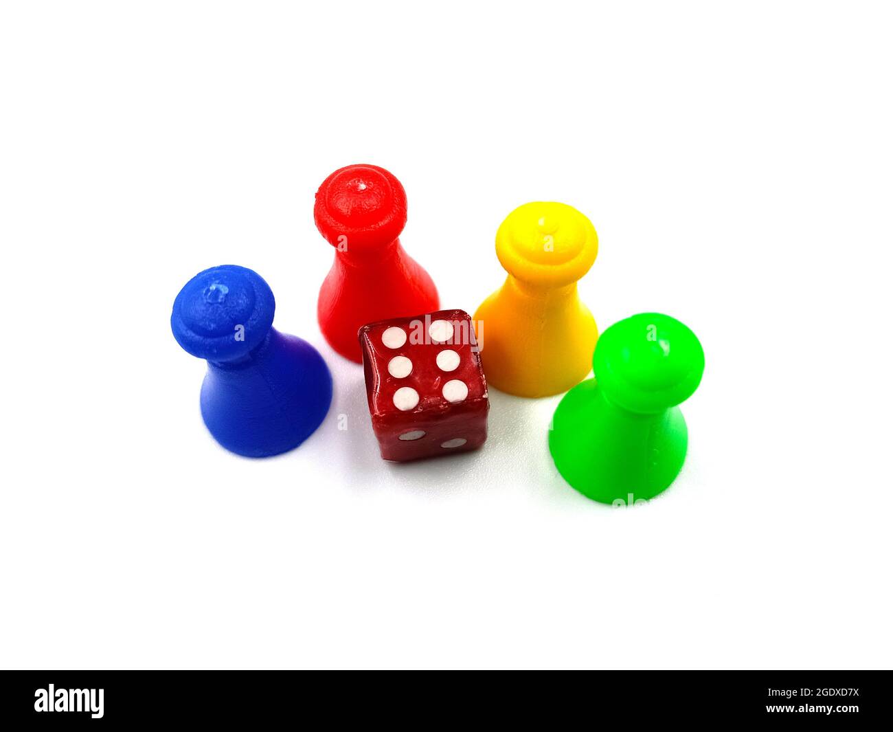 A top view of colorful plastic pawn chess pieces and dice for children ...