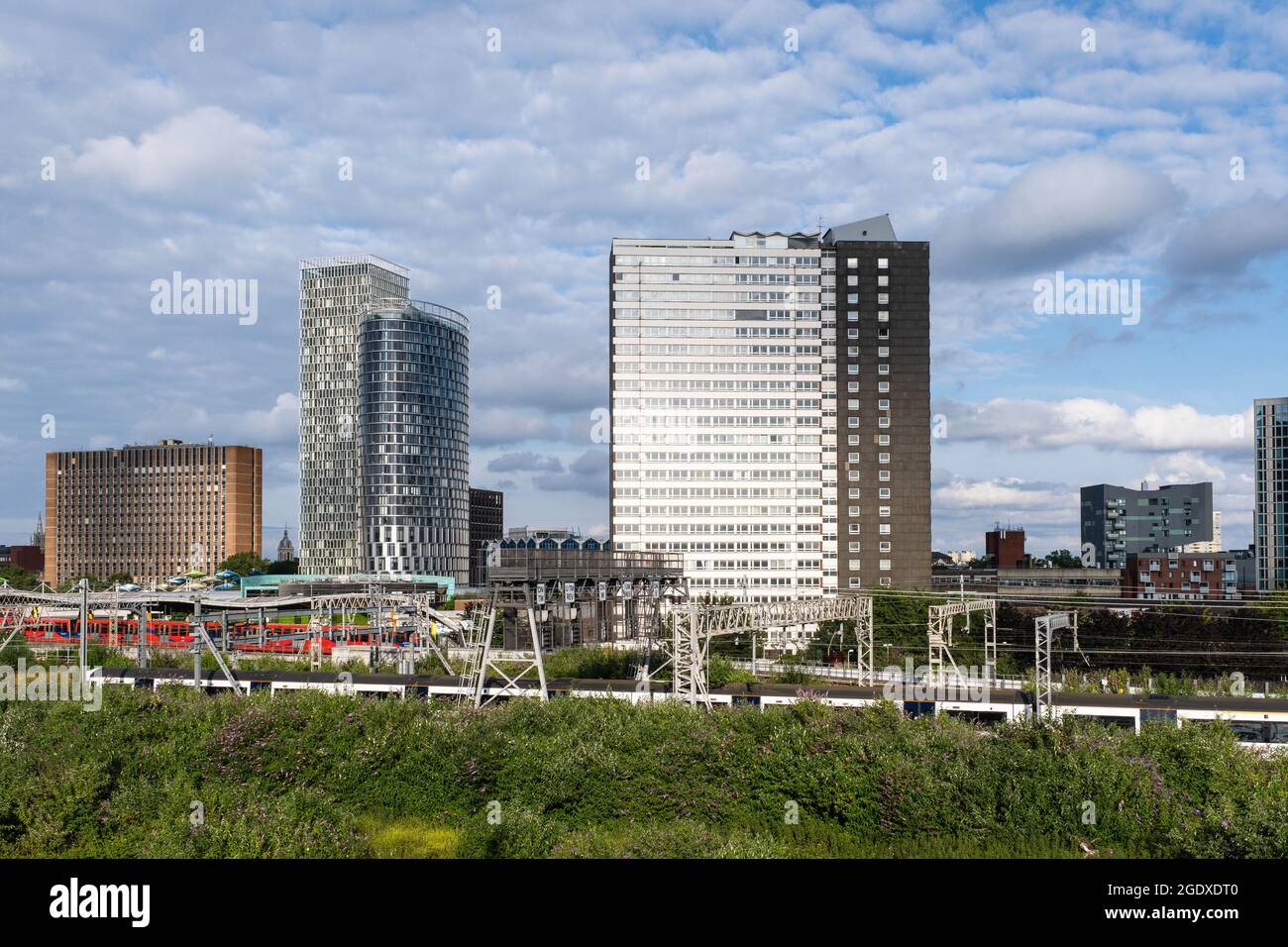 A view of modern and old tower blocks by the railway line in Stratford ...