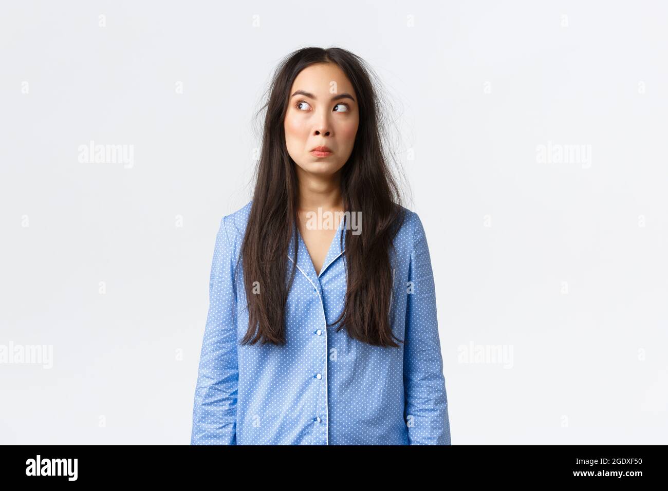 Confused and puzzled cute asian girl with messy hair, wearing blue ...