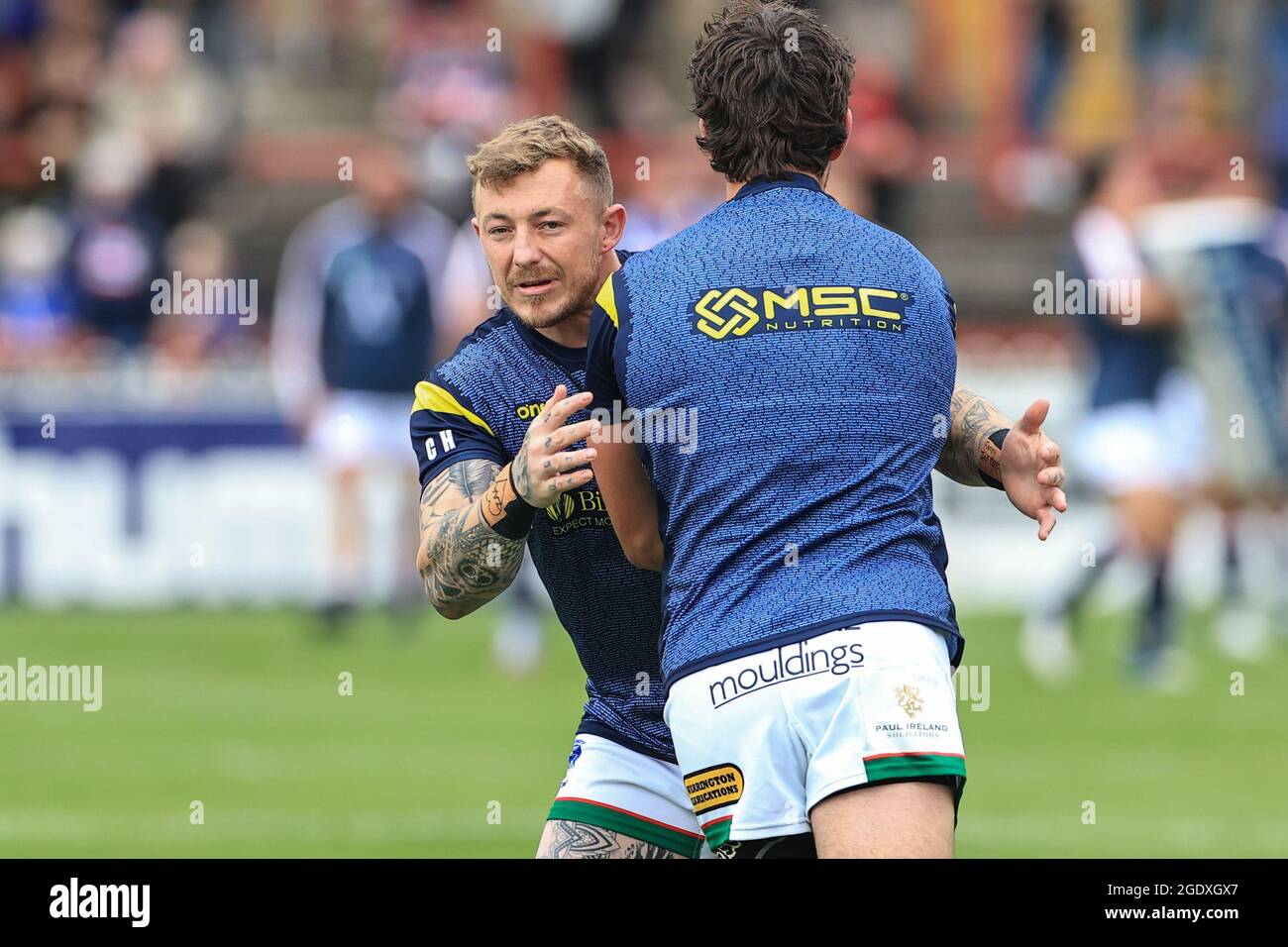 Josh Charnley (5) of Warrington Wolves and Stefan Ratchford (1) of ...