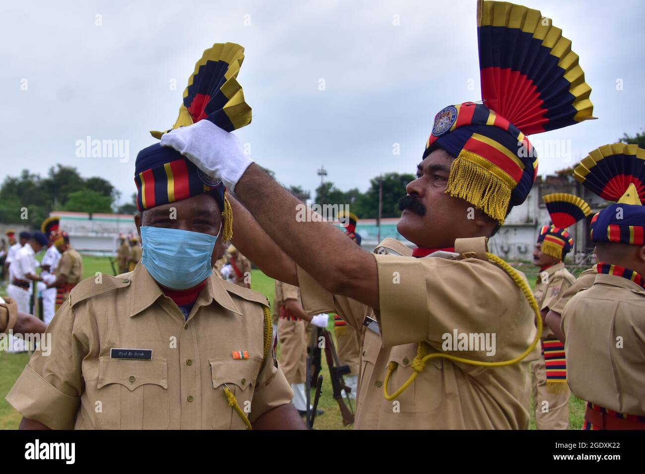 Nagaon. 15th Aug, 2021. An Indian policeman adjusts his colleague's ...