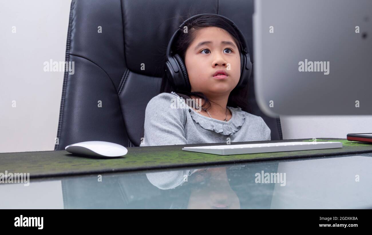 Asian girls study online with laptops. Kid wear headset typing keyboard ...