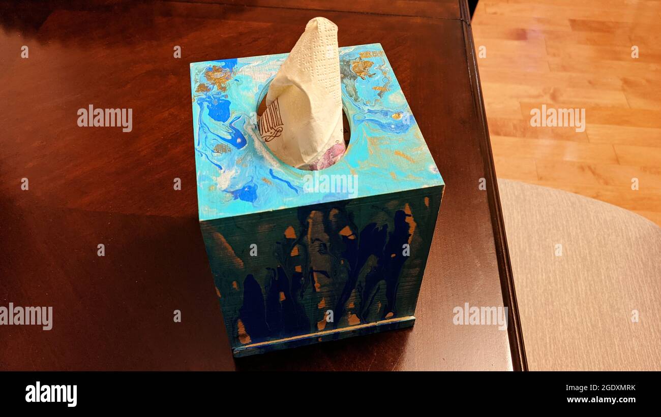 Painted tissue box in contrast of wooden surfaces Stock Photo - Alamy