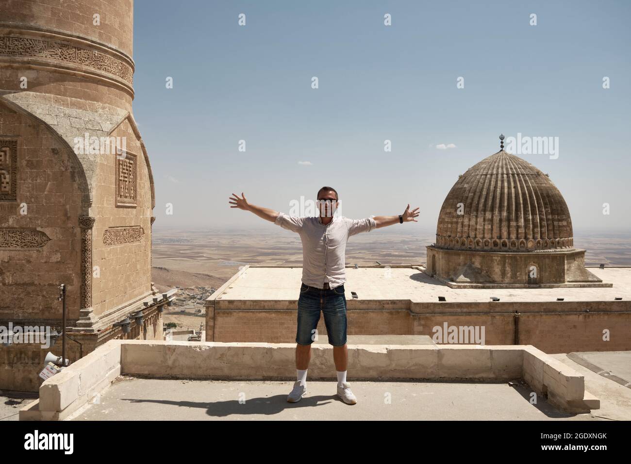 Happy man on roof arms hi-res stock photography and images - Alamy