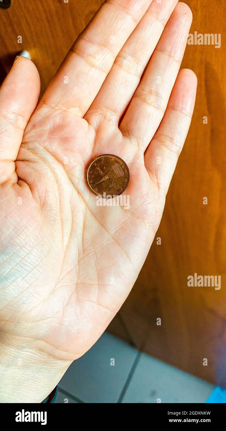 Old coin in hand hi-res stock photography and images - Alamy