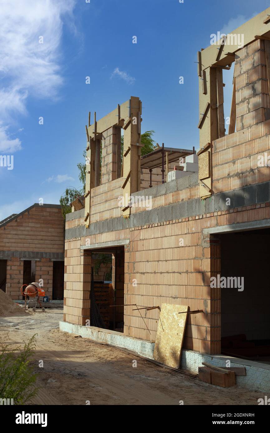 A vertical shot of a half-constructed building in a suburban area Stock ...