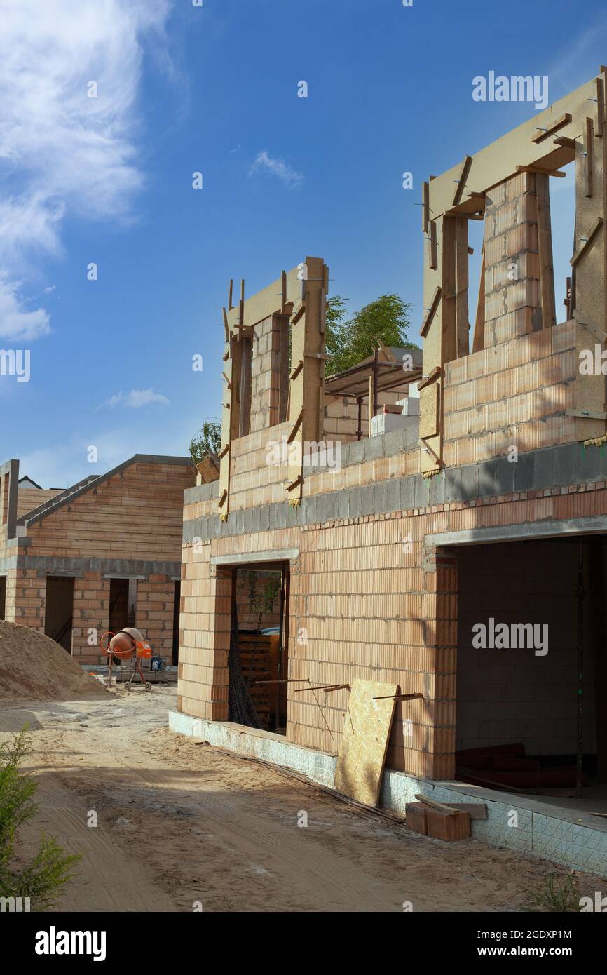 A vertical shot of a half-constructed building in a suburban area Stock ...