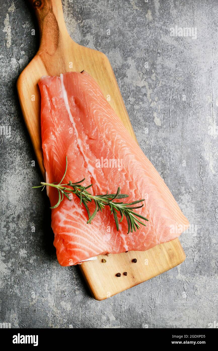 Raw salmon fillet on grey stone background, copy space Stock Photo - Alamy