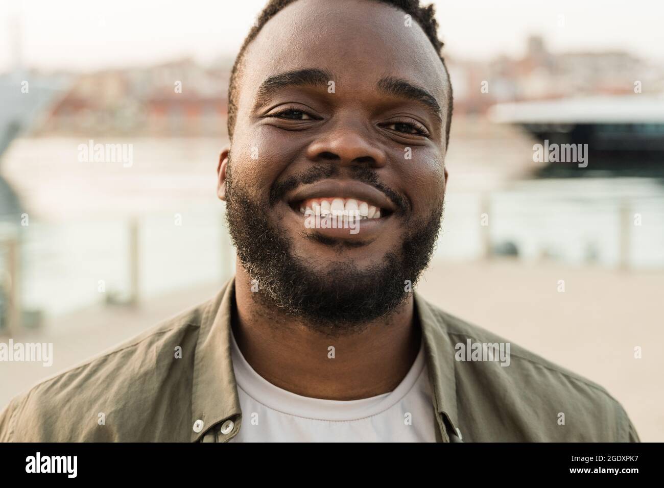 Young african american man smiling on camera outdoor at luxury yacht ...