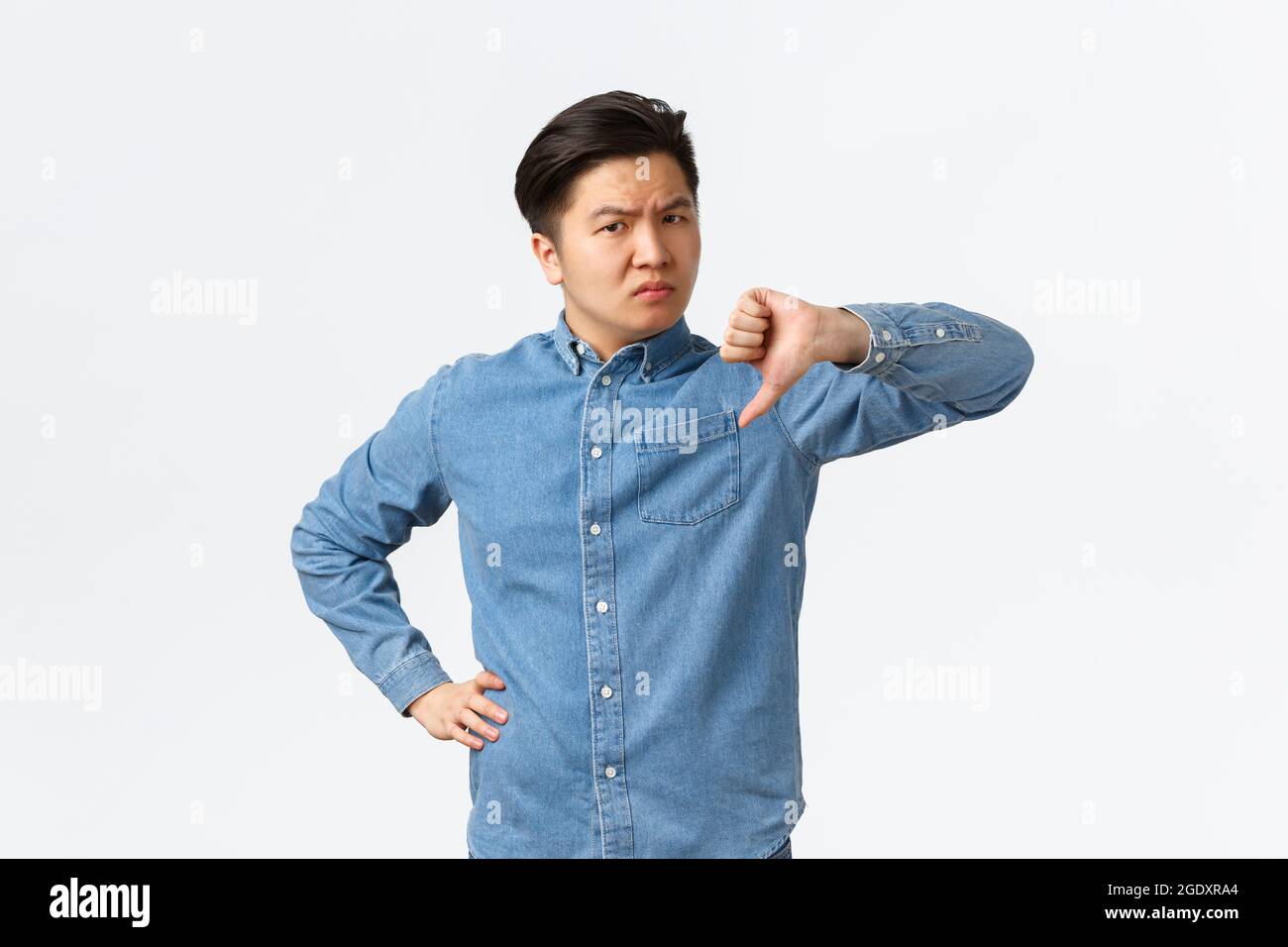 Disappointed skeptical asian man looking judgemental and unamused ...