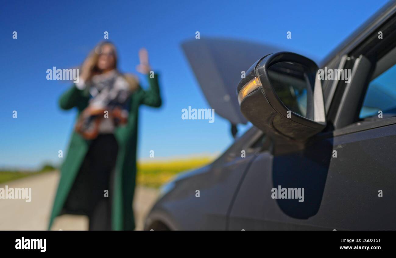 Woman near broken car calling for help Stock Photo - Alamy