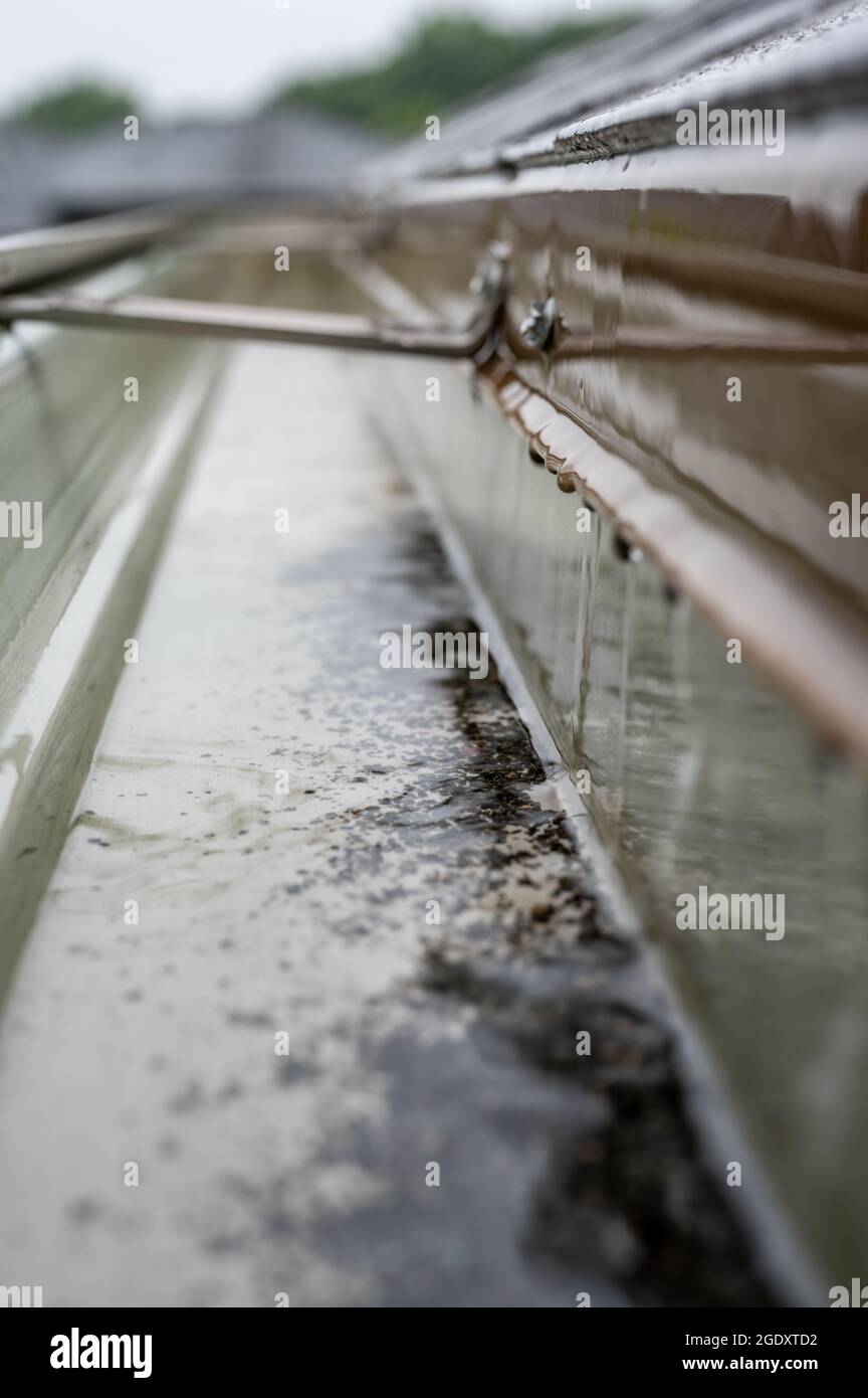 Selective focus on a section of residential guttering with hanger ...
