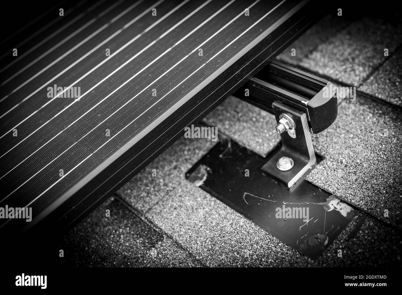 Rail, bracket, and anchor to a solar panel installed on a asphalt ...