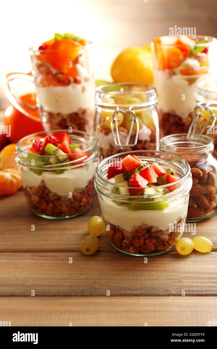 Healthy layered desserts with muesli and fruits on table Stock Photo ...
