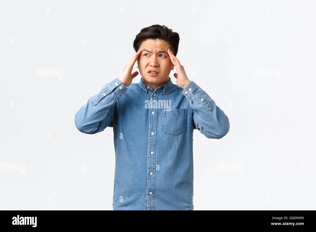 Troubled and uneasy asian man looking perplexed, having complicated ...