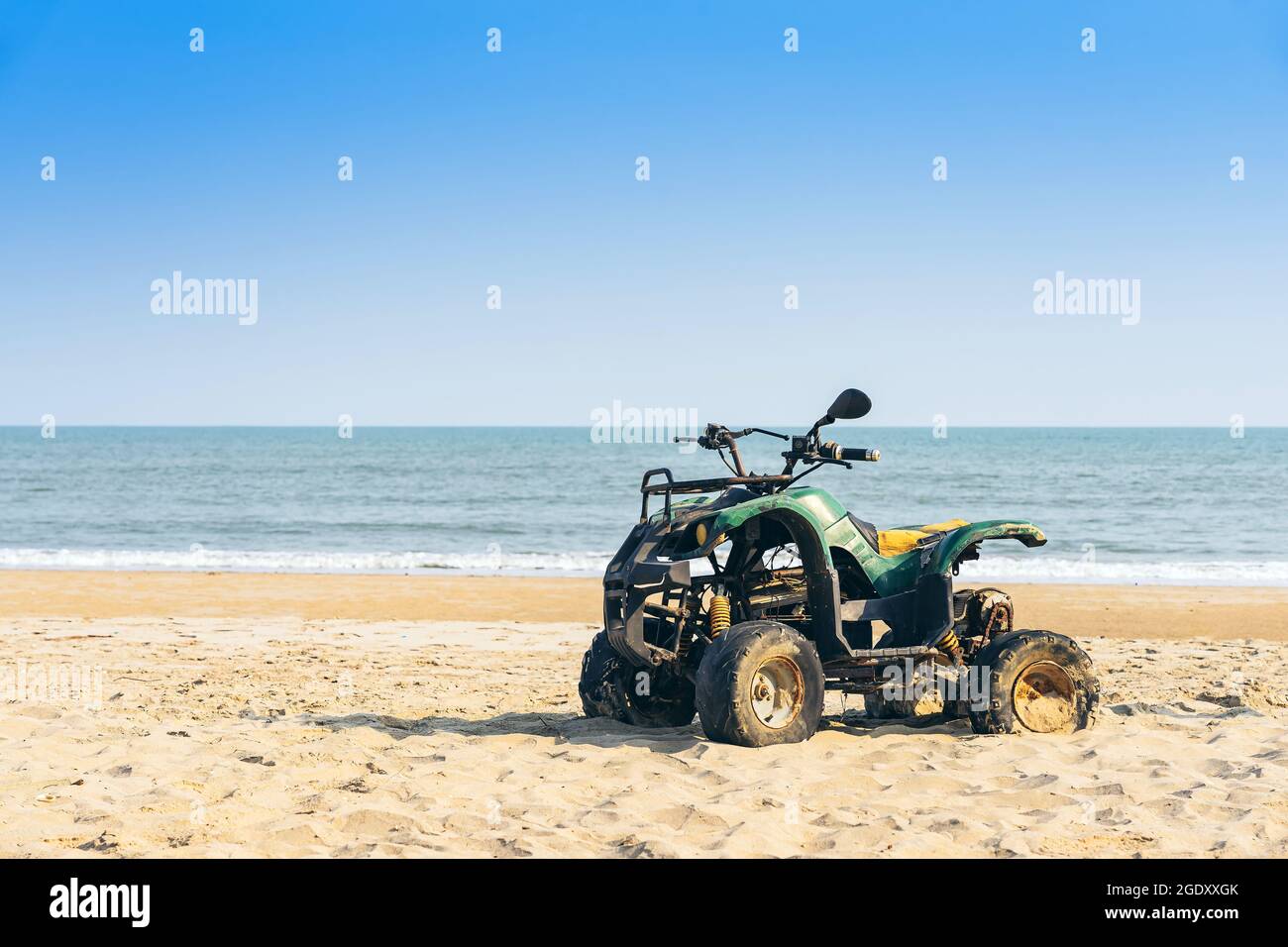 Vintage green ATV on the sandy beach. Quad ATV all terrain vehicle ...