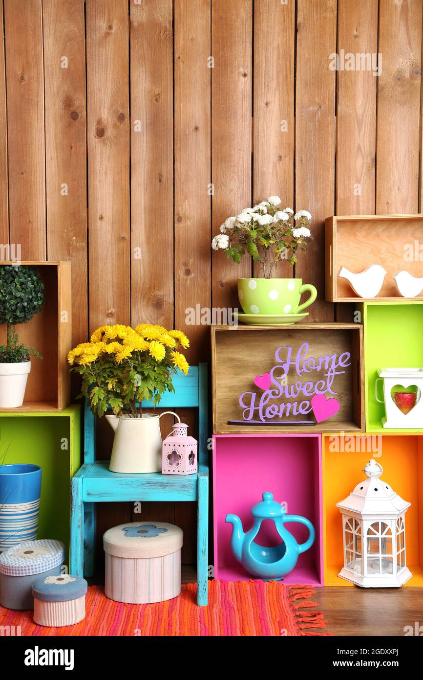 Beautiful colorful shelves with different home related objects on ...