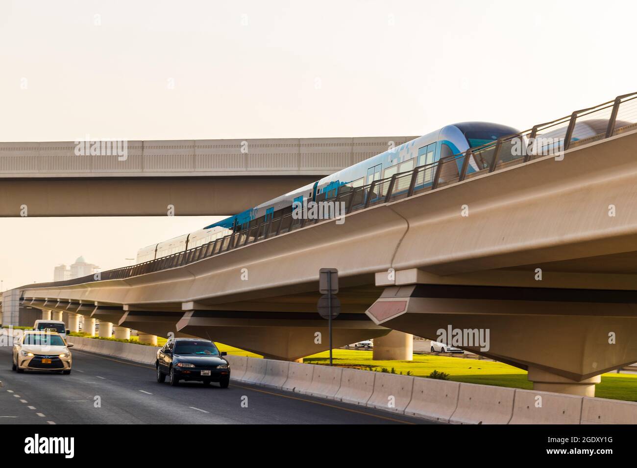 Dubai, UAE - 08.14.2021 - Two metro trains under flyover bridge Stock ...
