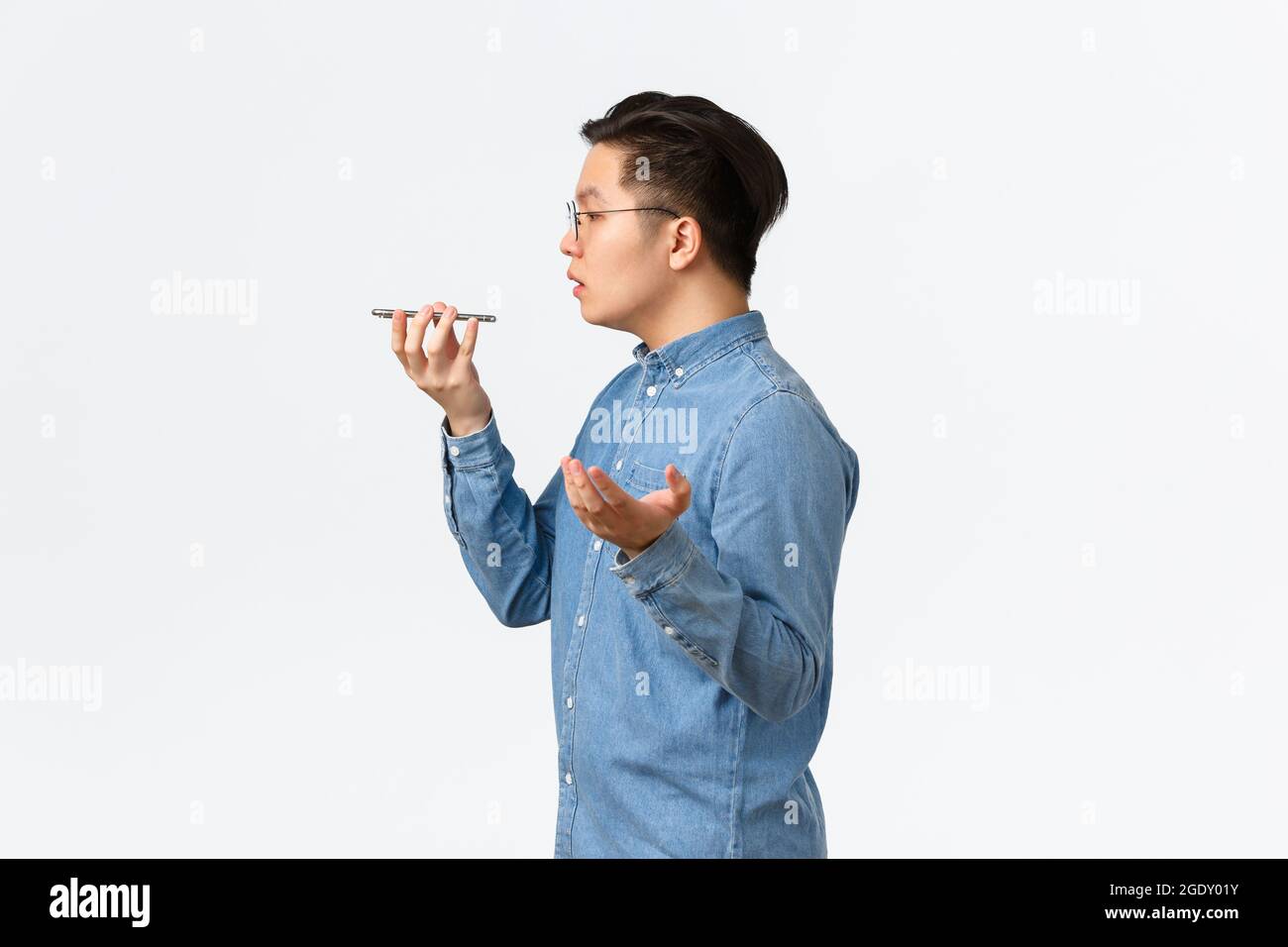 Profile of busy young asian male entrepreneur, freelancer record voice ...