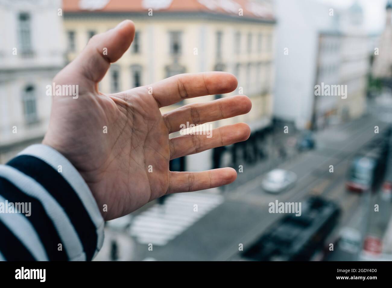 A man hand over a street background Stock Photo - Alamy
