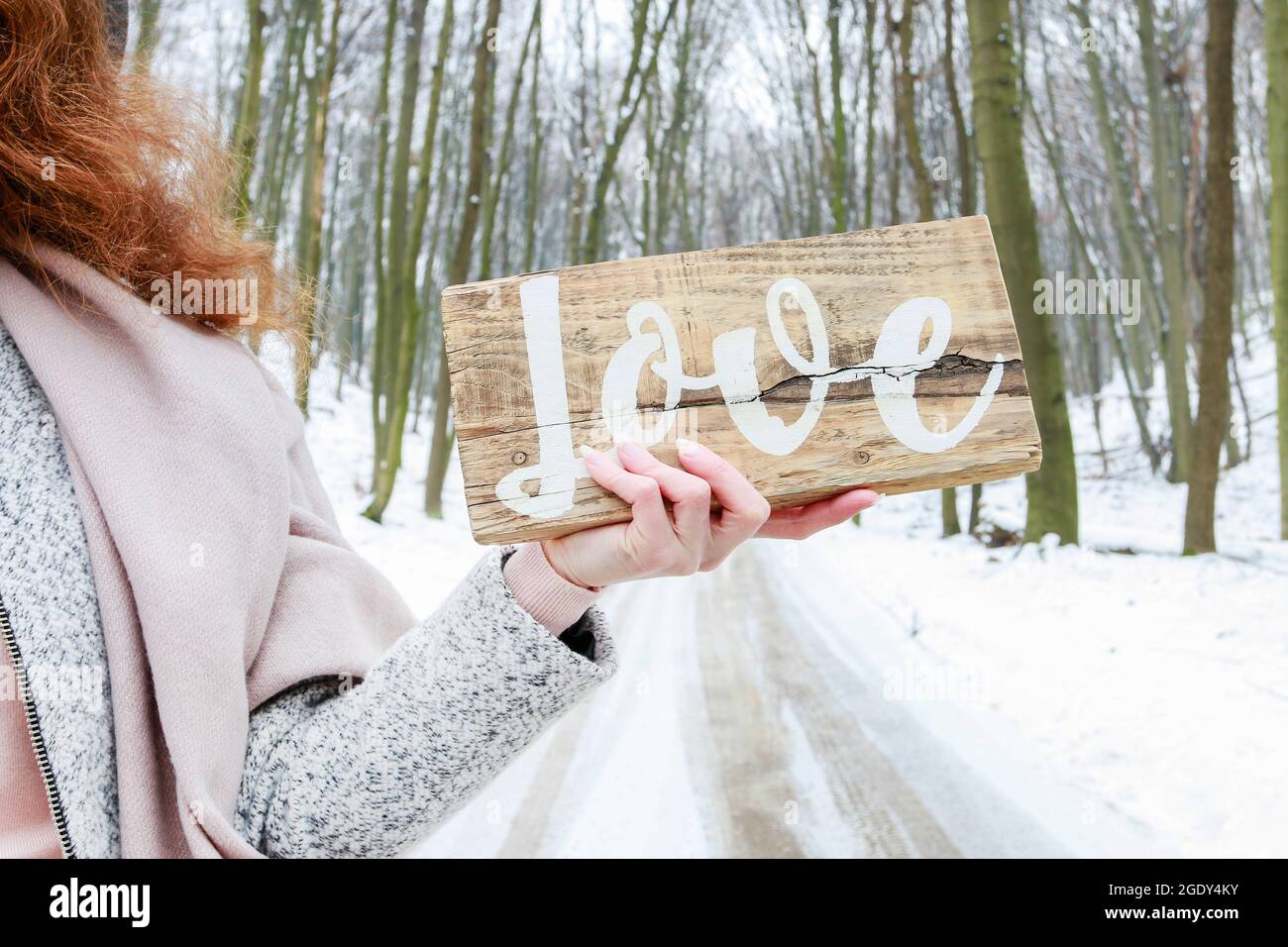 Love is always a right direction - conceptual image. Woman holding ...