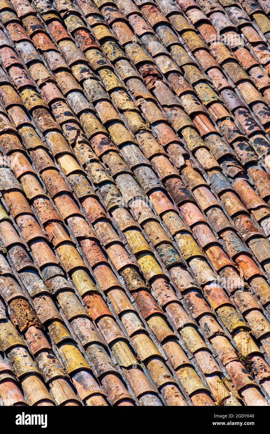Old roof of traditional Roman terracotta tiles on an old house in the ...