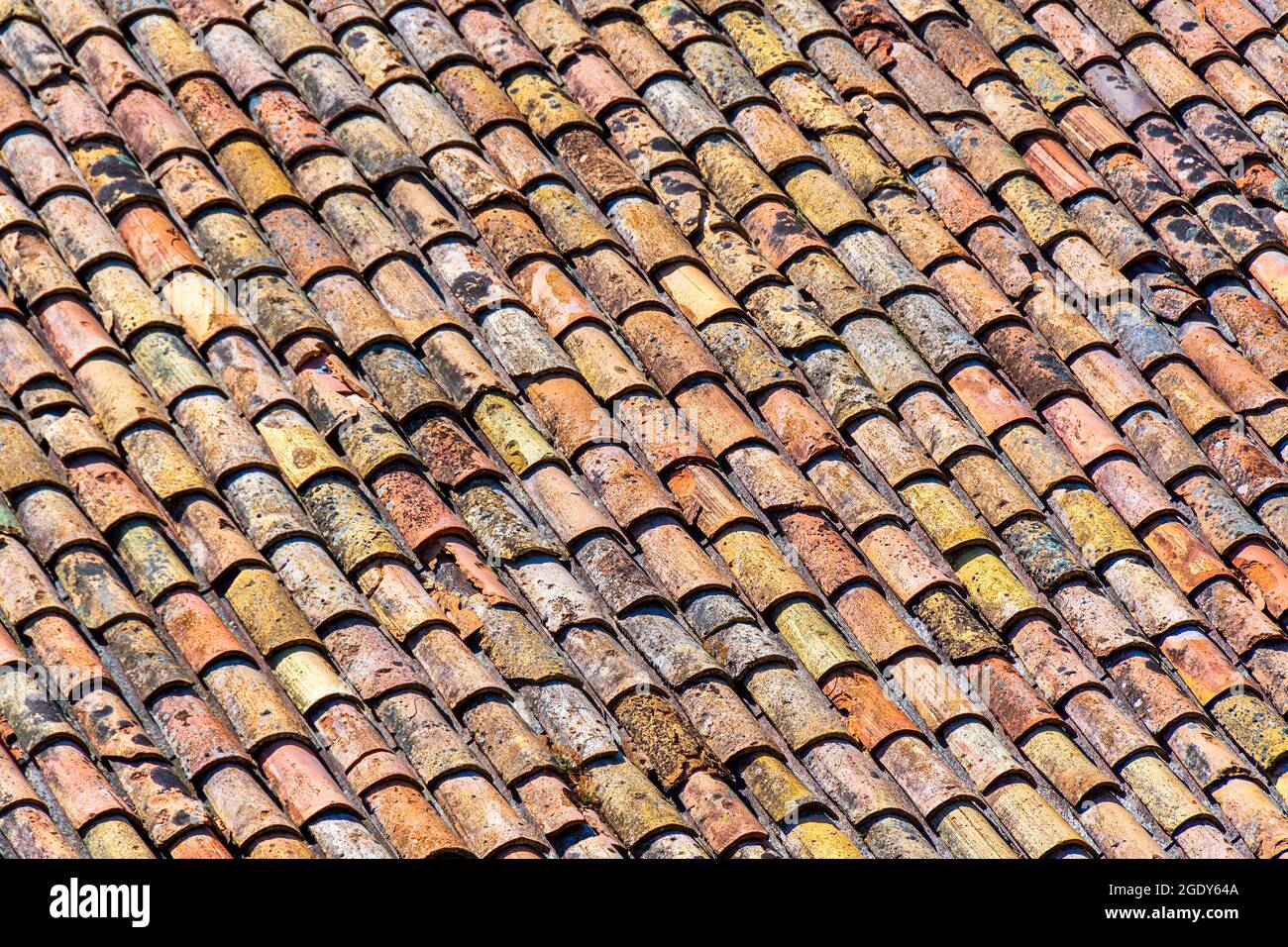Old roof of traditional Roman terracotta tiles on an old house in the ...