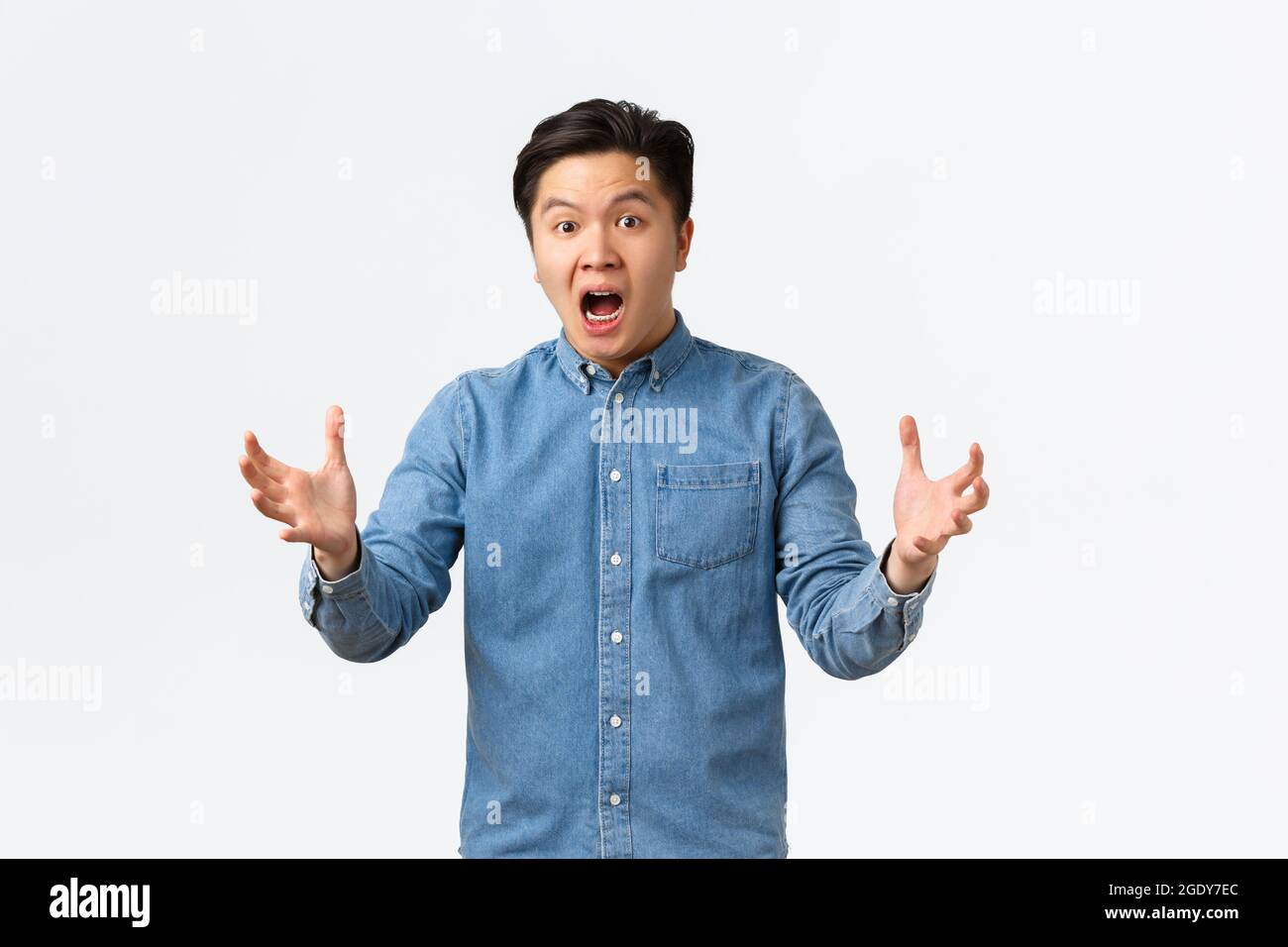 Shocked and alarmed asian man reacting to terrible news, standing in ...