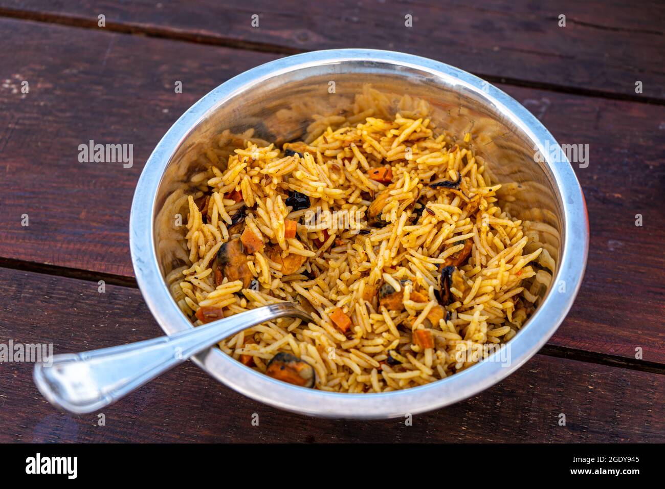 Rice with mussels eating out Stock Photo - Alamy