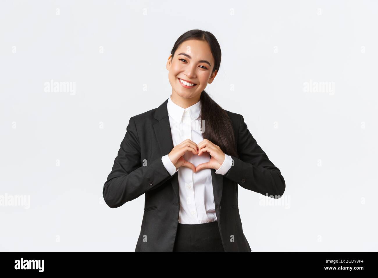 Cheerful successful asian businesswoman in black suit care for her ...