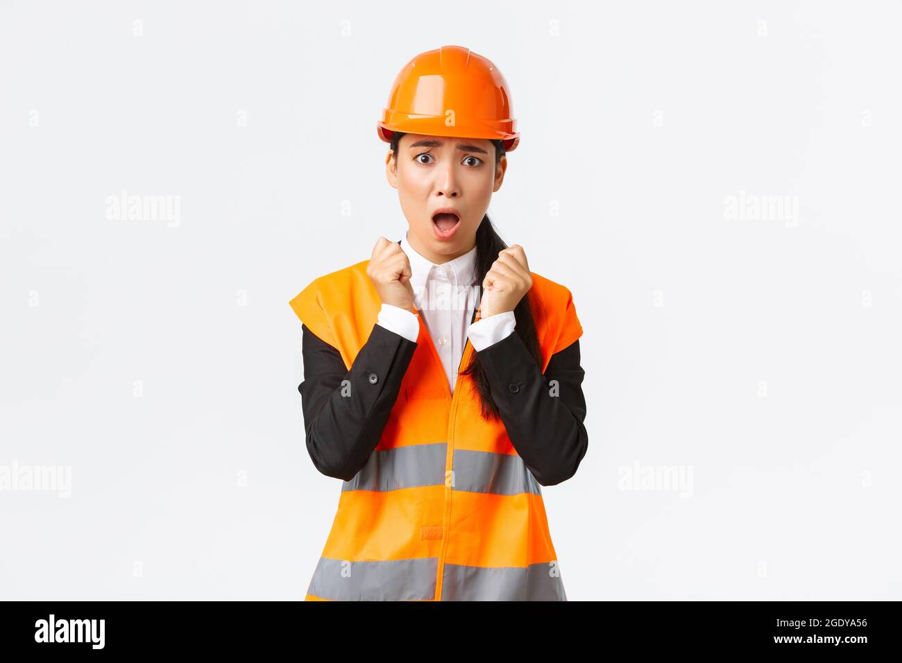 Scared asian female engineer in panic looking shocked and afraid ...