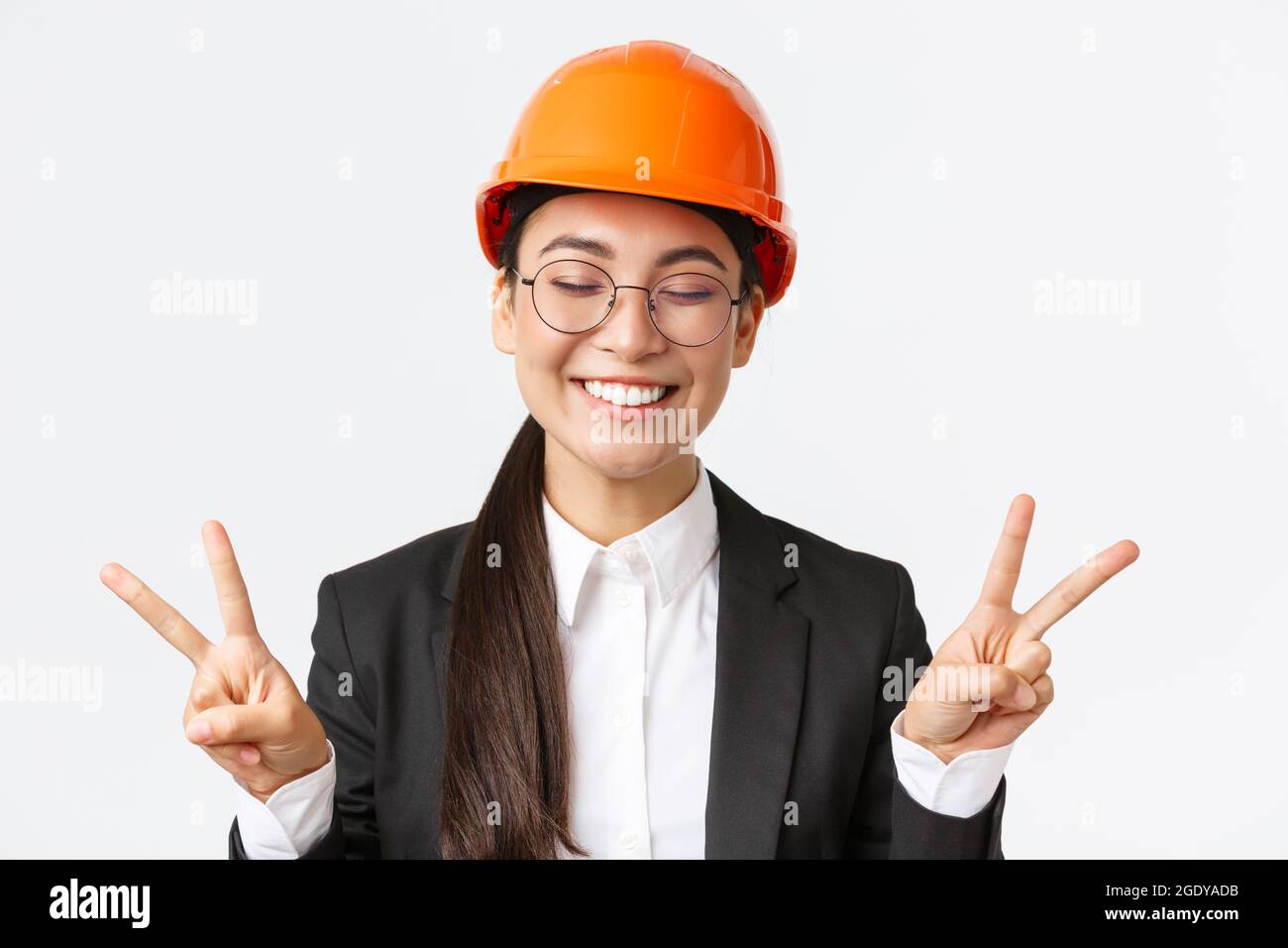 Close-up of cheerful successful female asian engineer, construction ...