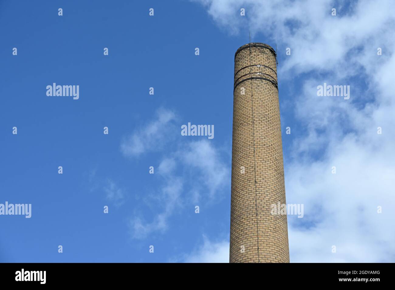 Yellow brick industrial chimney against a blue summer sky Yellow brick ...