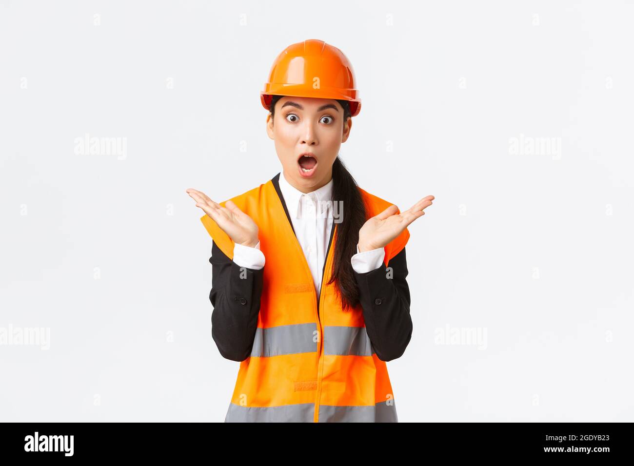 Surprised and shocked asian female engineer in reflective jacket ...