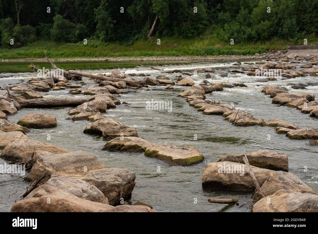 A cascading rock dam on a river Stock Photo - Alamy