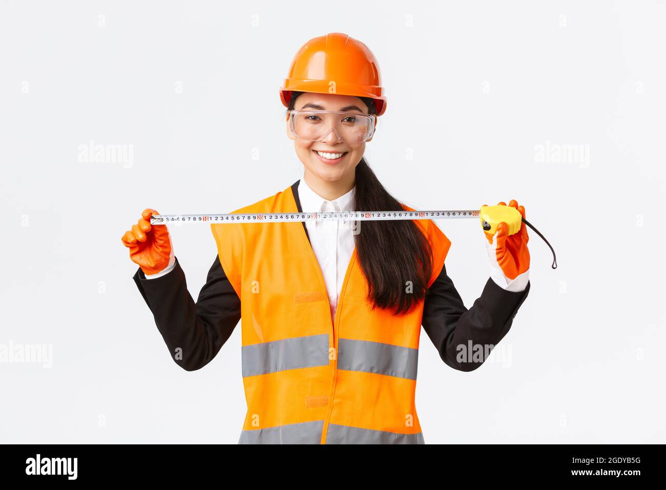 Confident professional female asian architect measuring layout, wearing ...