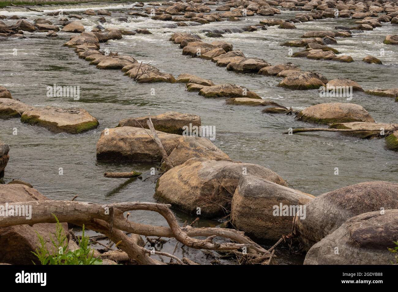 A cascading rock dam on a river Stock Photo - Alamy