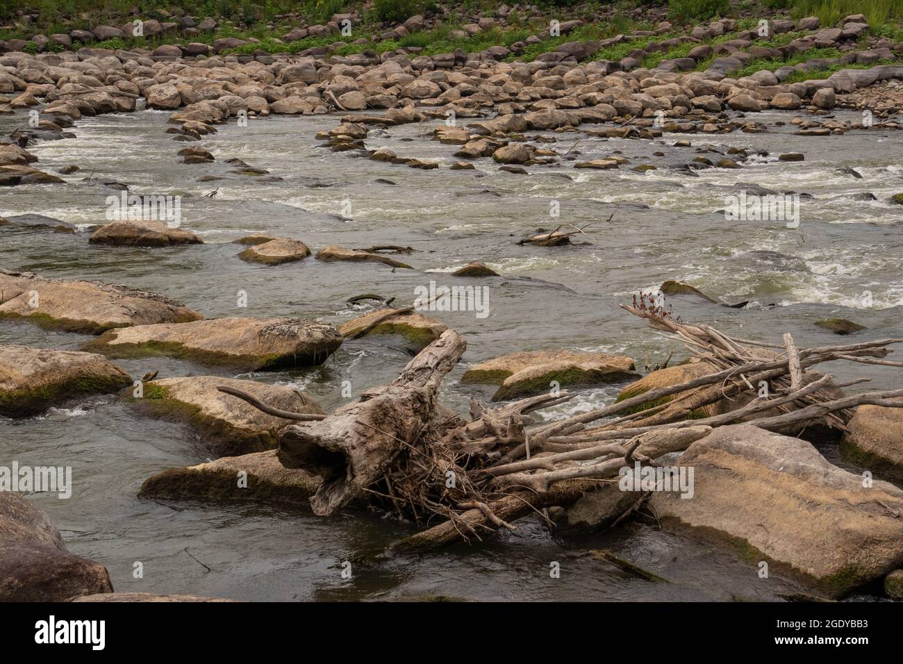 A cascading rock dam on a river Stock Photo - Alamy