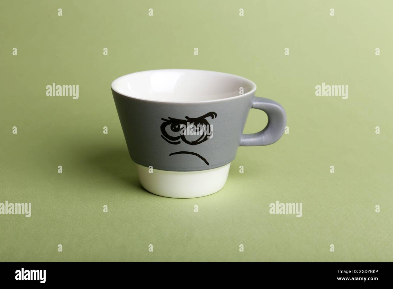 Emotional cup on green background Stock Photo - Alamy