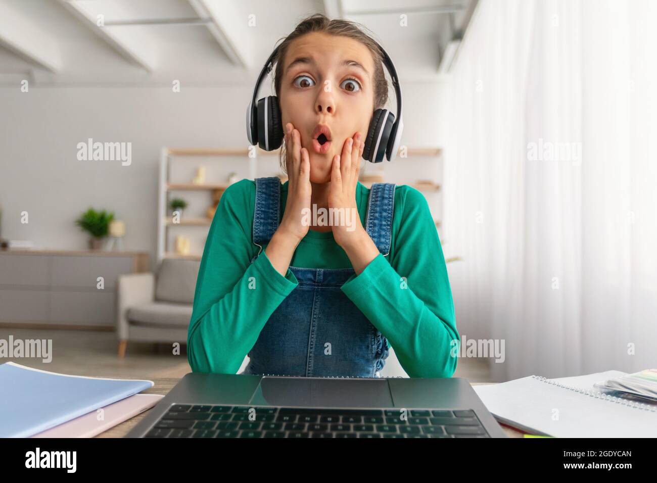 Surprised girl sitting at desk, having video call wearing headset Stock ...