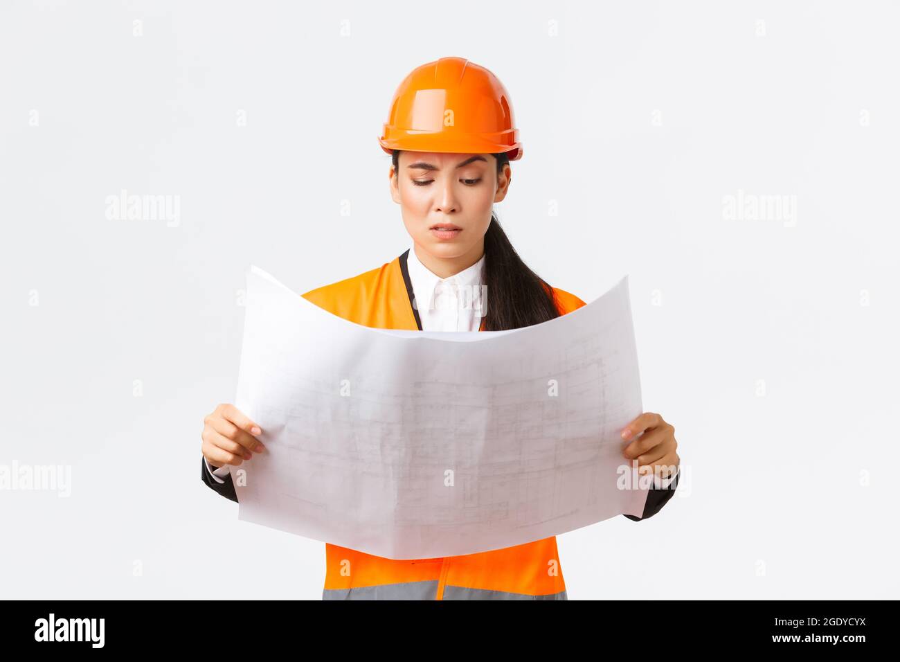 Confused and doubtful asian female chief engineer, lead architect at ...