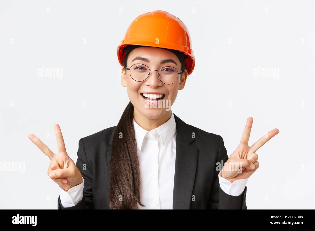 Close-up of cheerful successful female asian engineer, construction ...