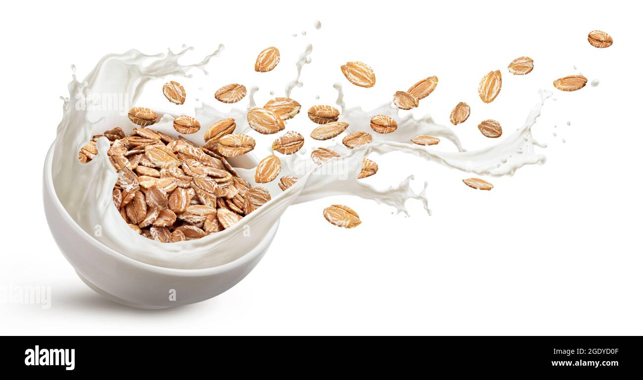 Oat flakes with milk splashes isolated on white background Stock Photo ...