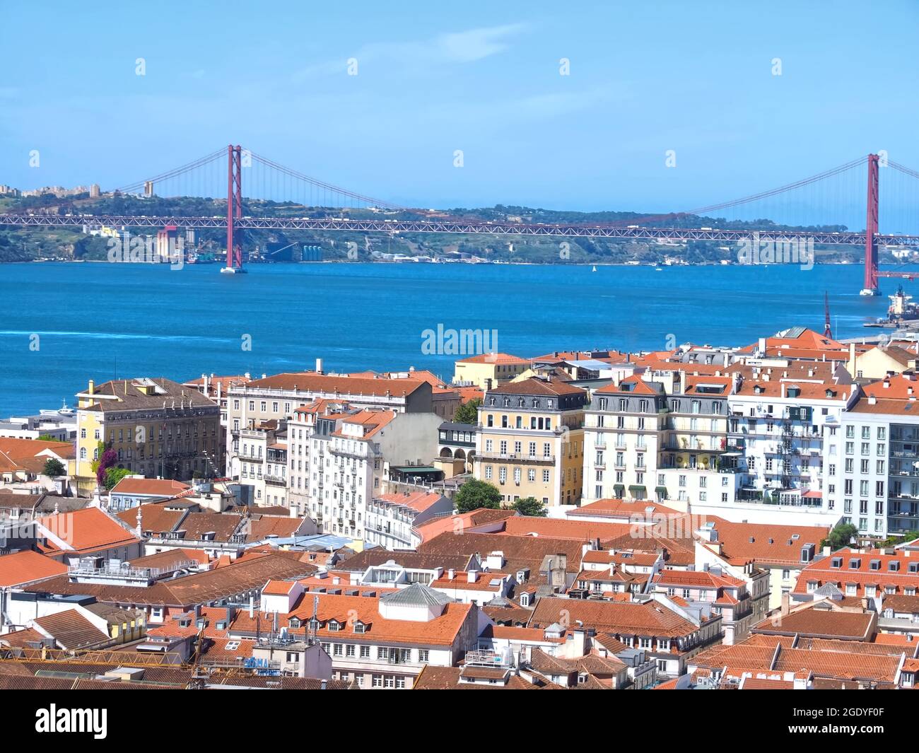 An aerial view of Lisbon city with red 25 April bridge and Tejo river ...