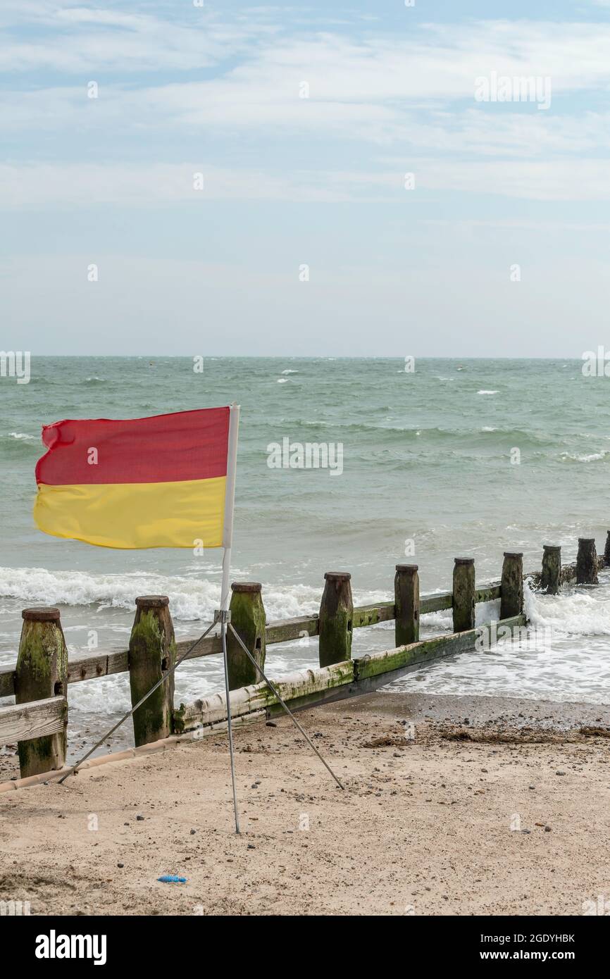Red and yellow warning sign flag marking the limit of the safe at sea ...