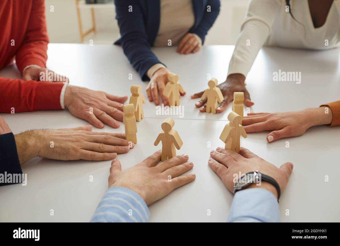 Diverse team of business people join little human figures as symbol of ...