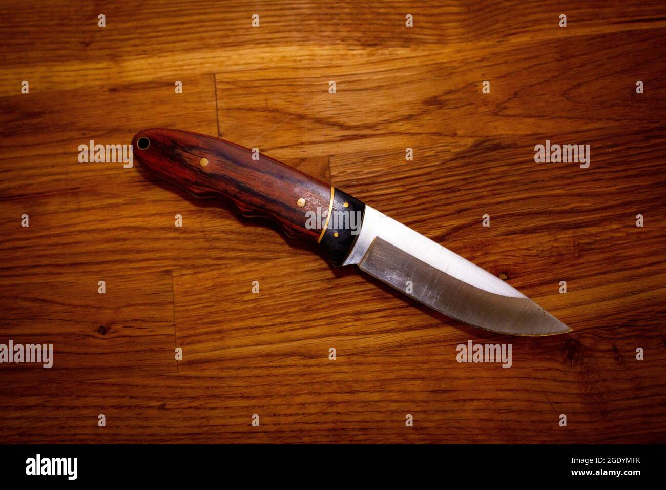 A top view of a small sharp knife on the wooden floor Stock Photo - Alamy