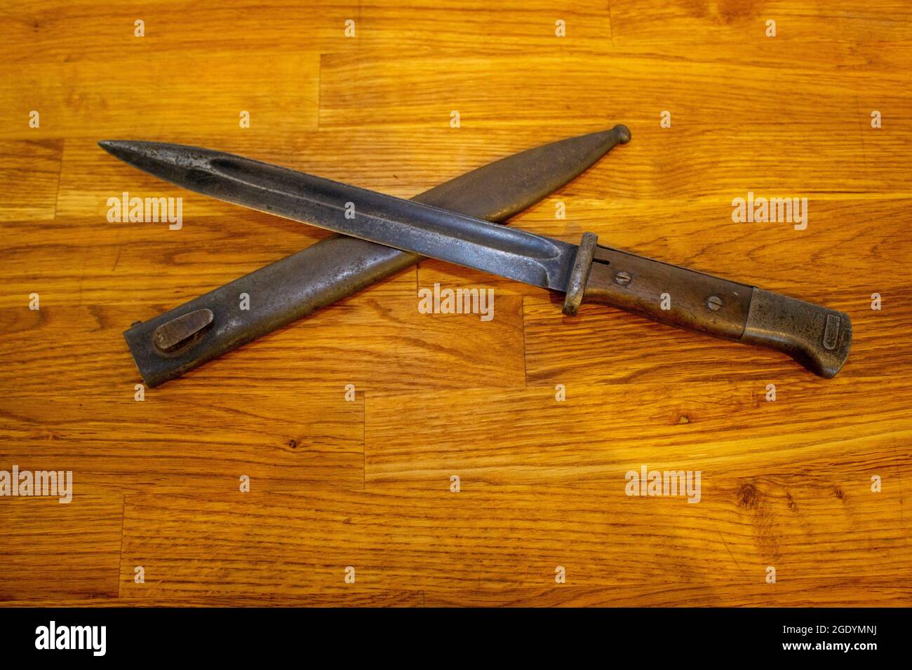 A top view of an old antique long sharp knife with its metal case on ...