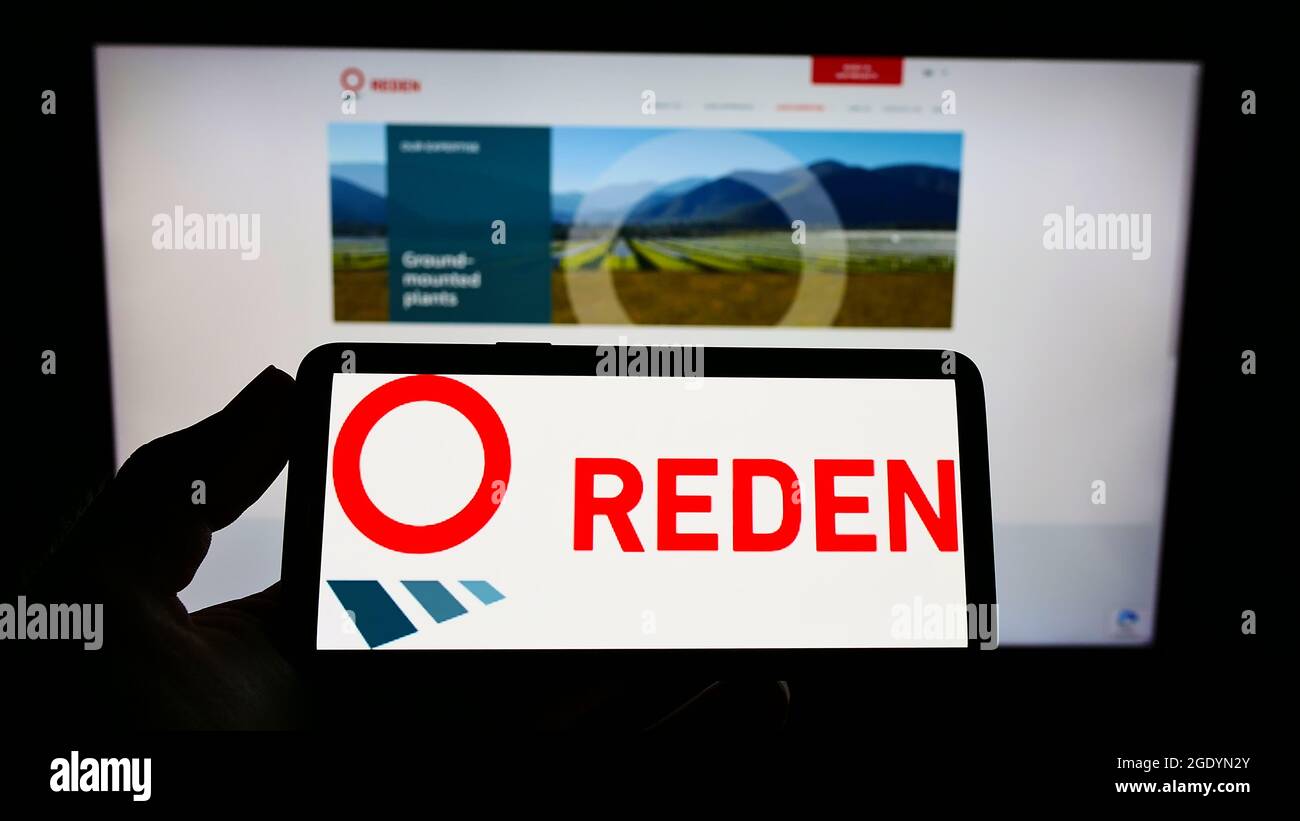 Person holding smartphone with logo of French photovoltaic company ...