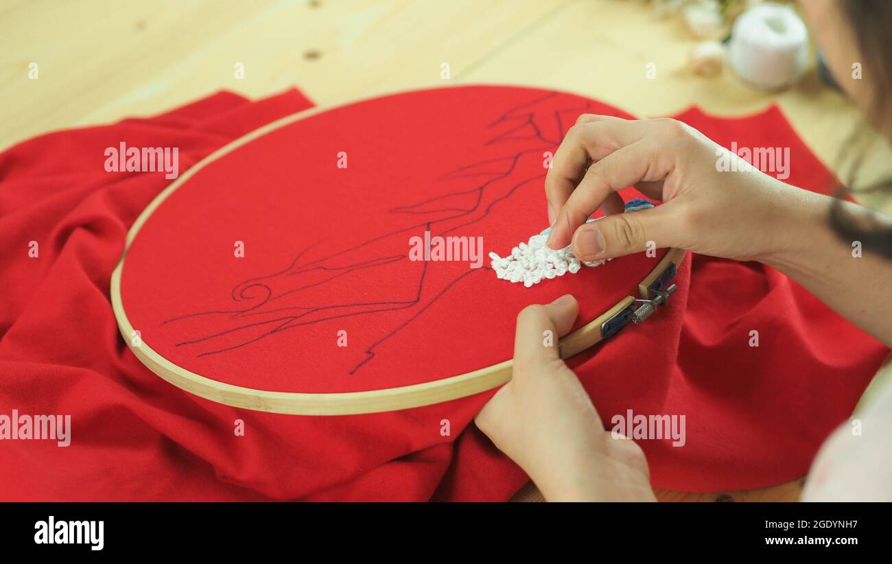 Woman hands and craft work. Embroider sewing by hand. Handicraft work ...